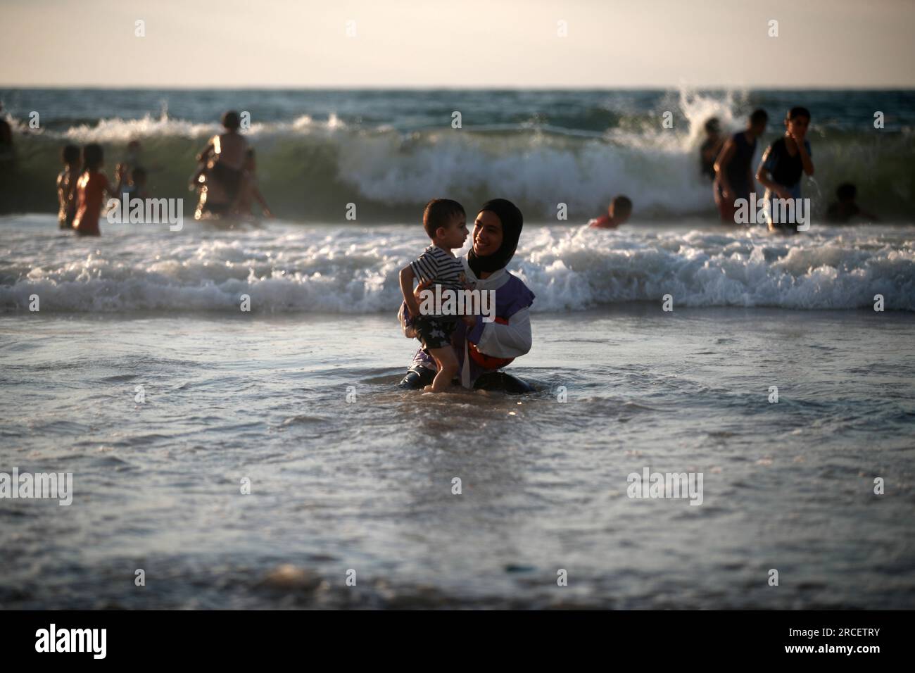 Palestinians gather at the beach in the Mediterranean Sea on the third ...