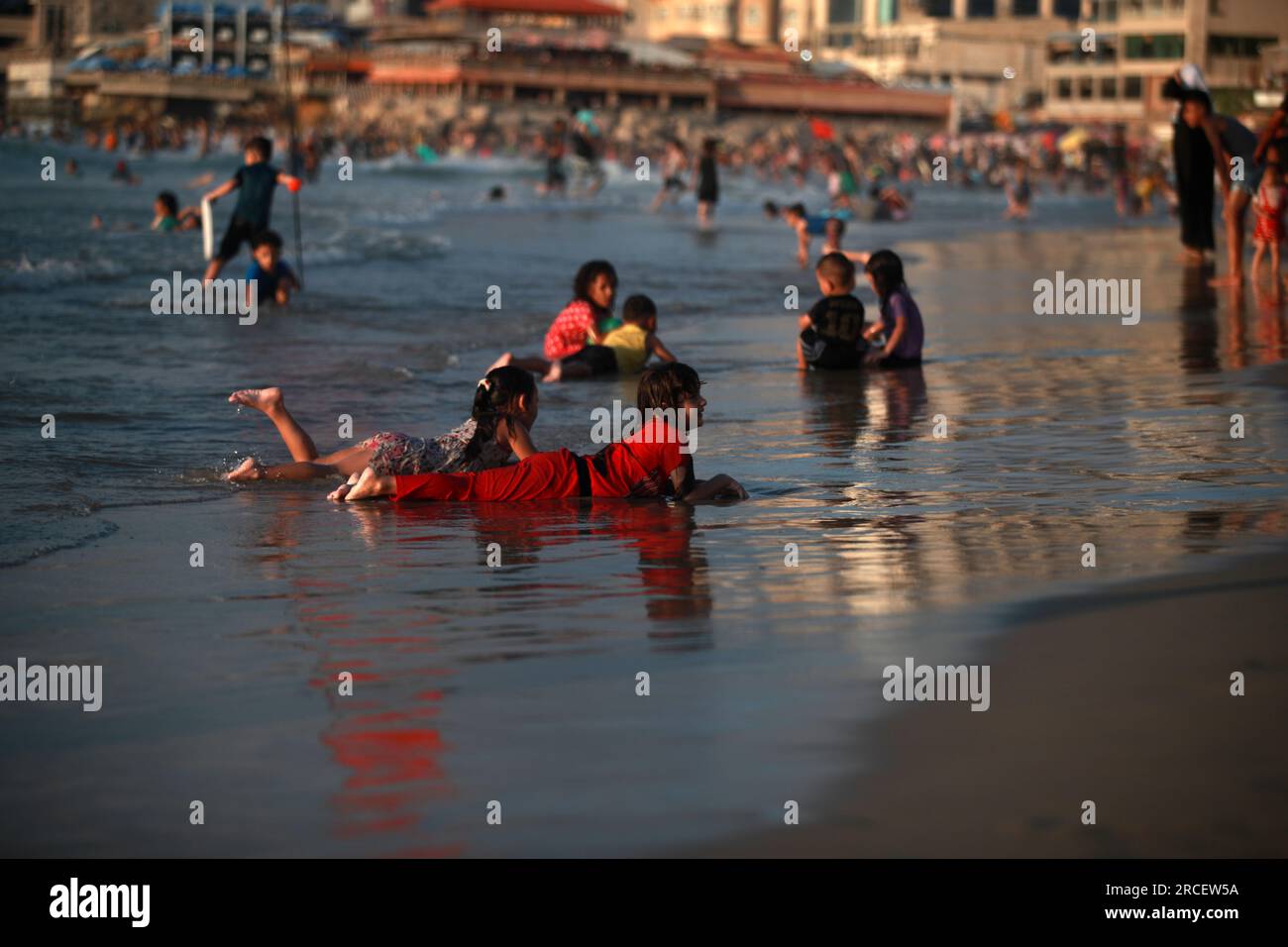 Palestinians gather at the beach in the Mediterranean Sea on the third ...