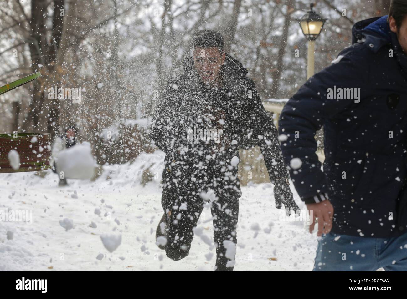 People are playing in the snow on the hiking trail of Tochal Peak. they ...