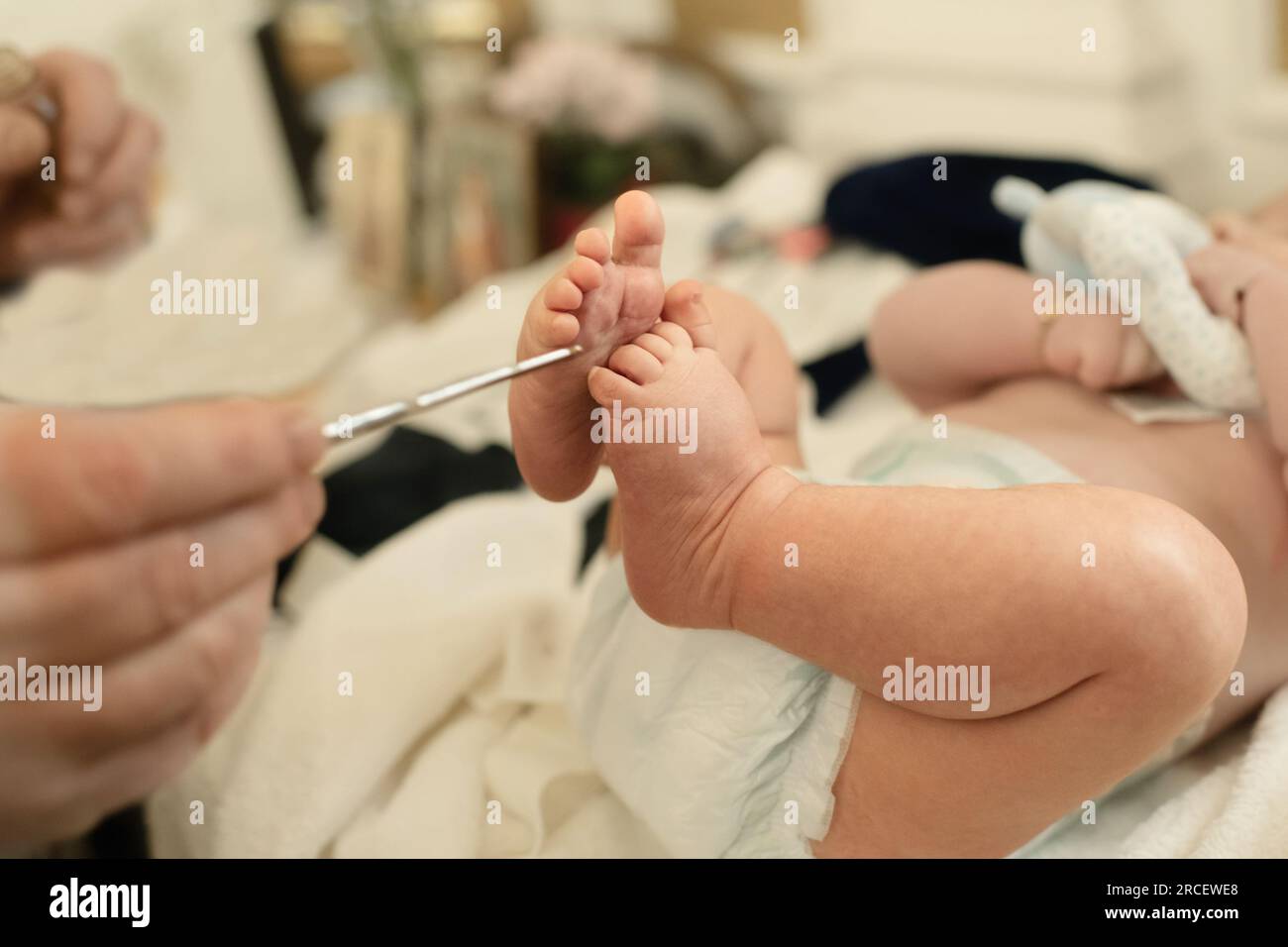 Anointing with oil in baptism with hands of priest Stock Photo - Alamy