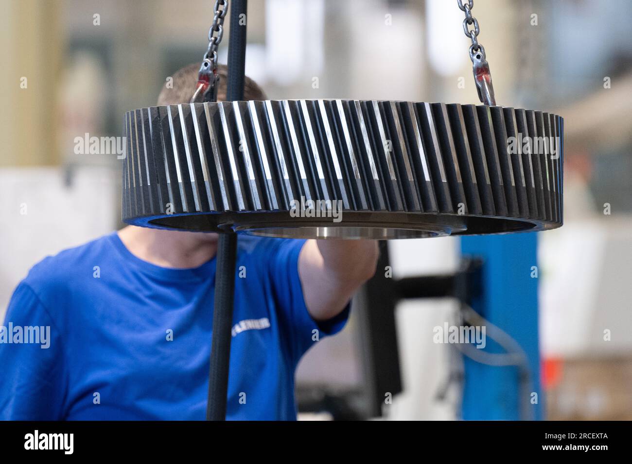Penig, Germany. 14th July, 2023. An employee works on a gear wheel in a ...