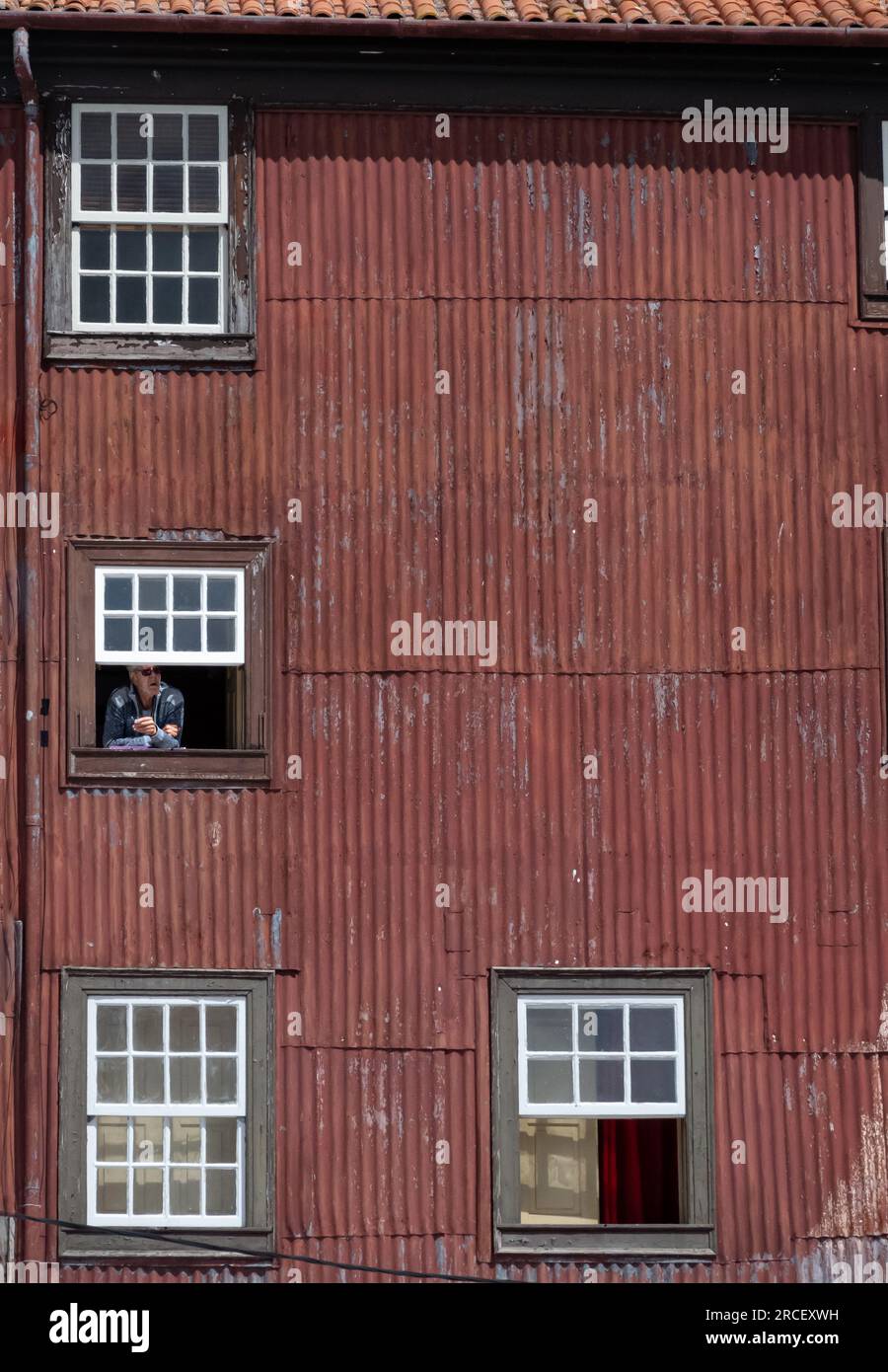 Porto, Portugal - 25 April, 2023: Man smoking in window of old red ...