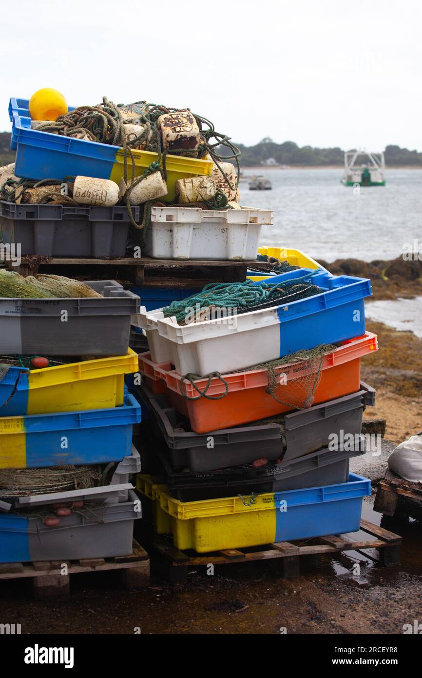 Boxes for fishing and nets are placed on the landing quay of the ...