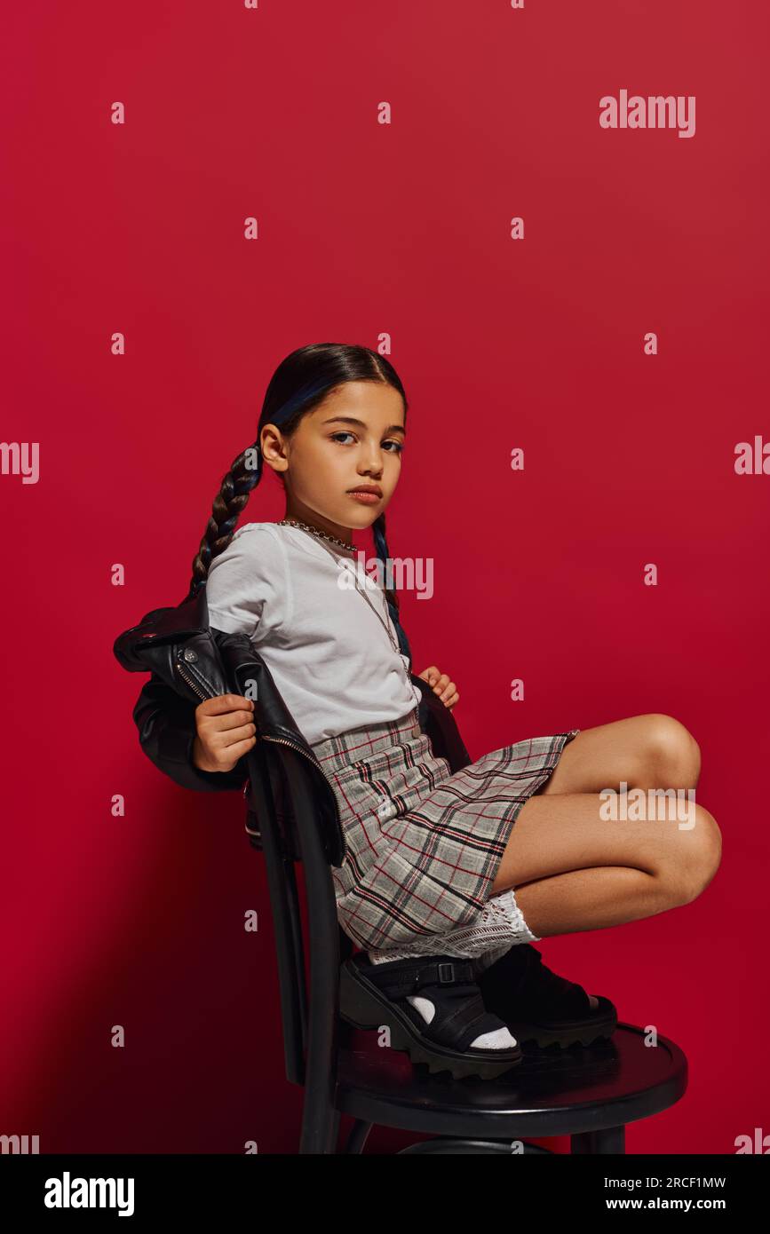 Trendy preteen girl with hairstyle posing in leather jacket and ...