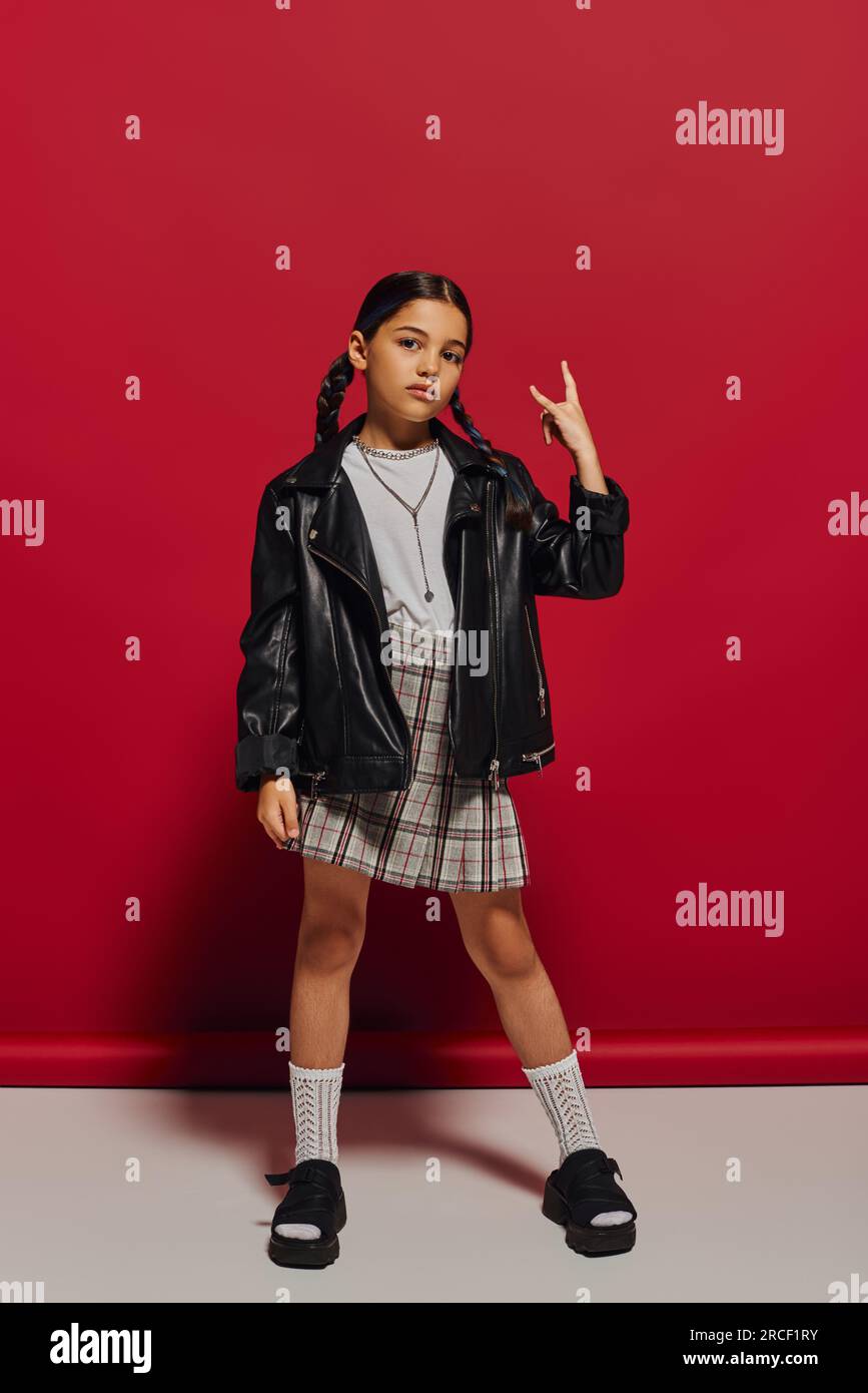 Full length of fashionable preteen girl with hairstyle wearing leather ...
