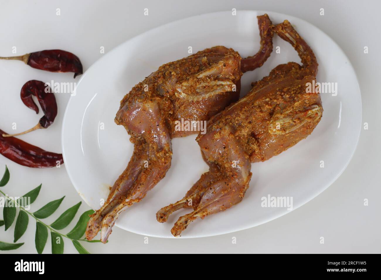 Marinated Quail meat. Quail meat marinated with red chili powder ...
