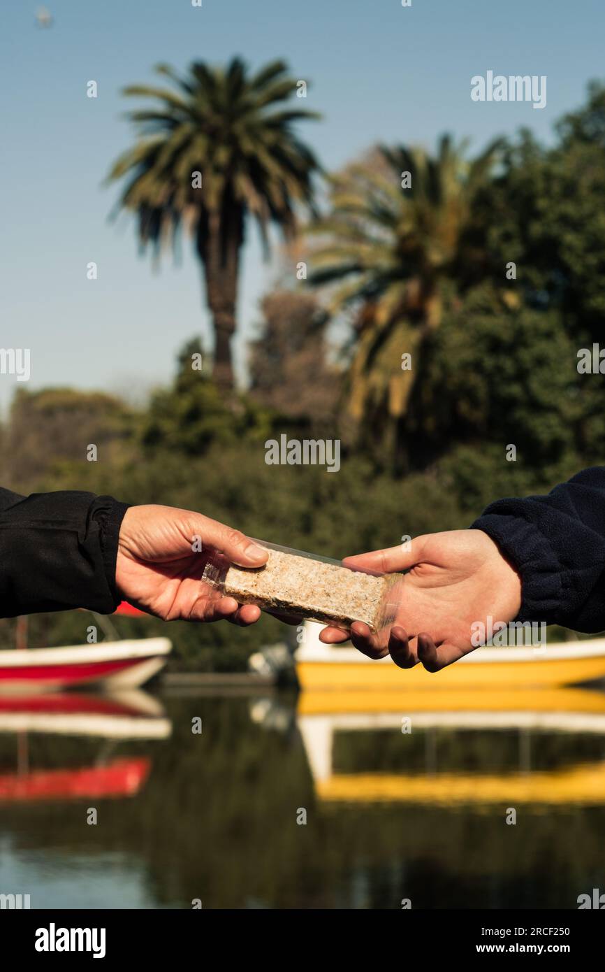 Healthy Lifestyle. Man giving a Granola Bar to another Man on the ...