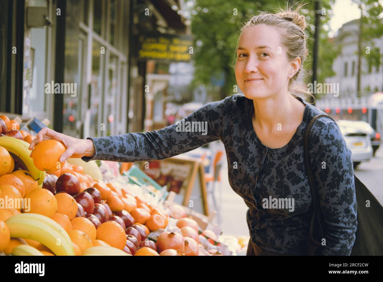 Woman choosing fruits on stand hi-res stock photography and images - Alamy