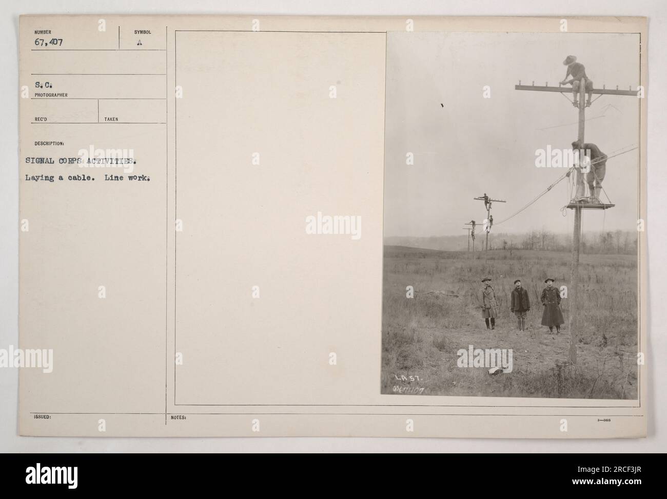 Photograph depicts American soldiers from the Signal Corps laying a ...