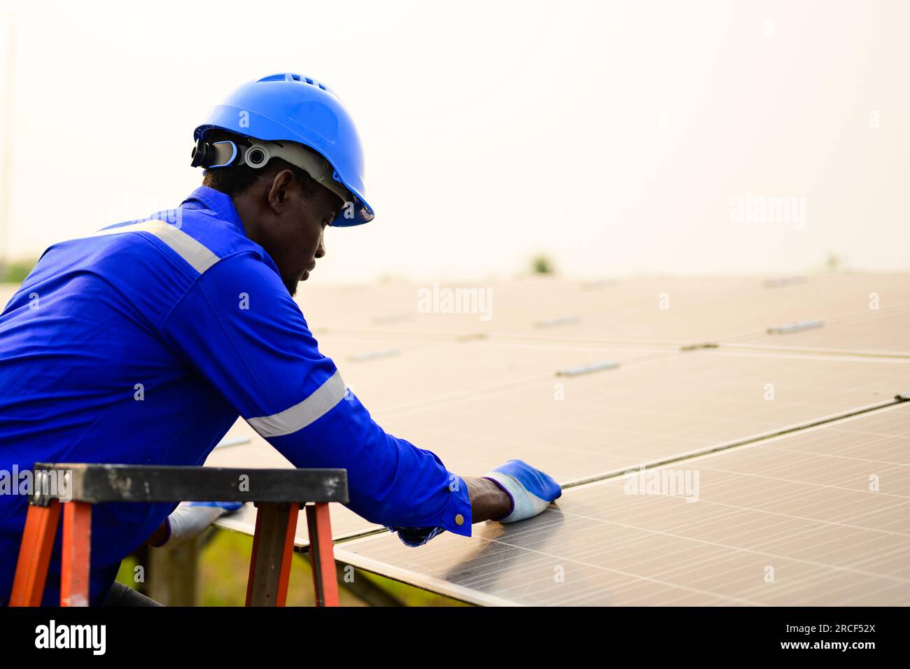 Engineer worker checking and maintaining solar panels on solar farm ...