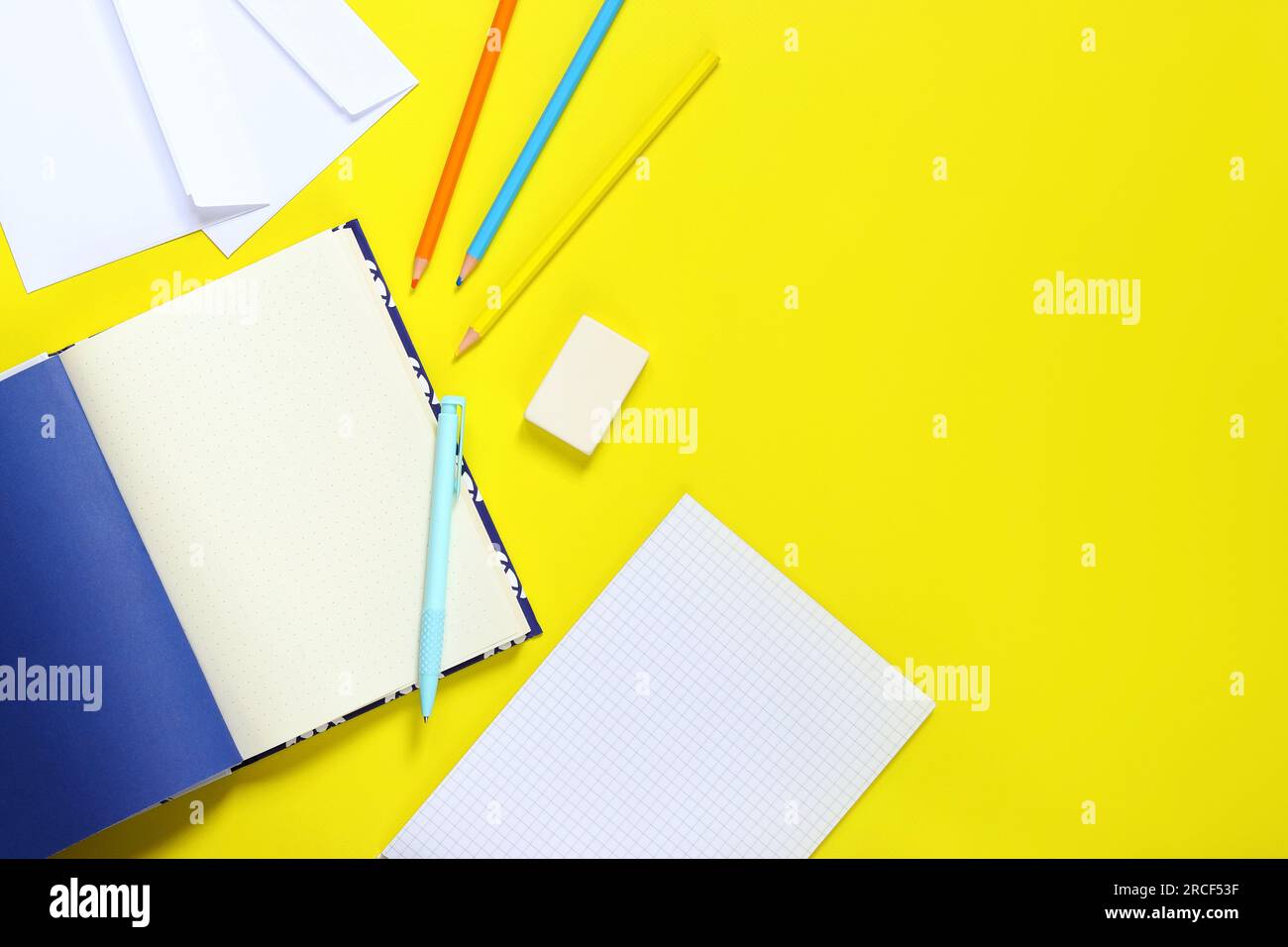 Back to school. Workspace, top view, flat lay. Open notepad, pencils ...