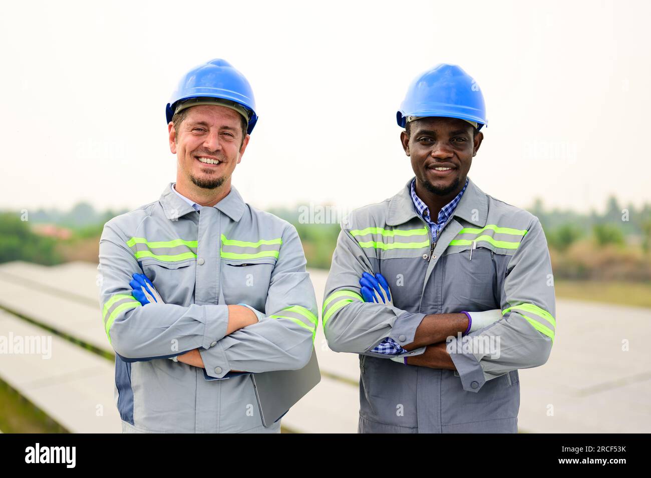 Happy maintenance engineers checking and maintaining solar panels Stock ...