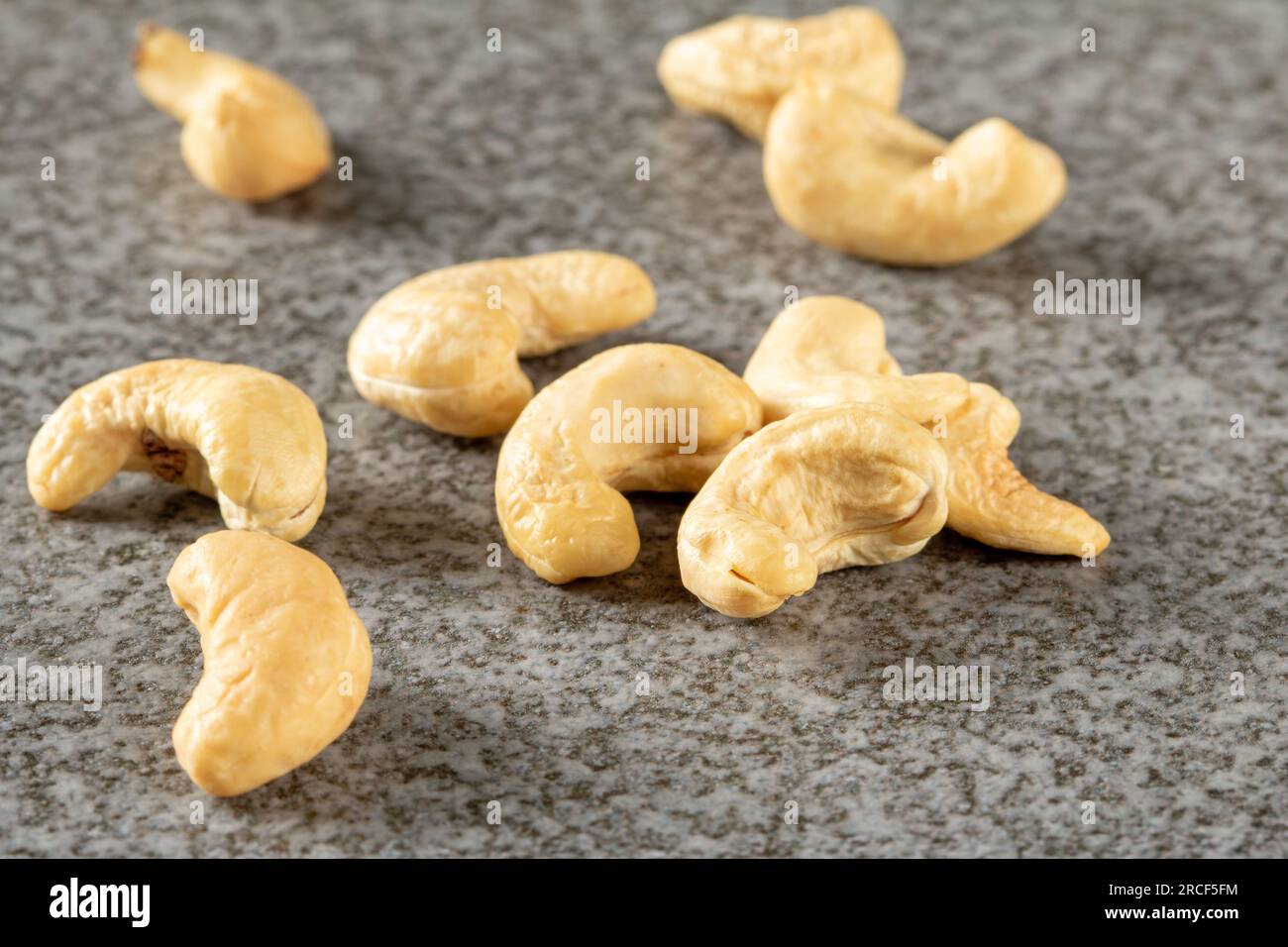 A bunch of cashew nuts on a stone stand close-up Stock Photo - Alamy