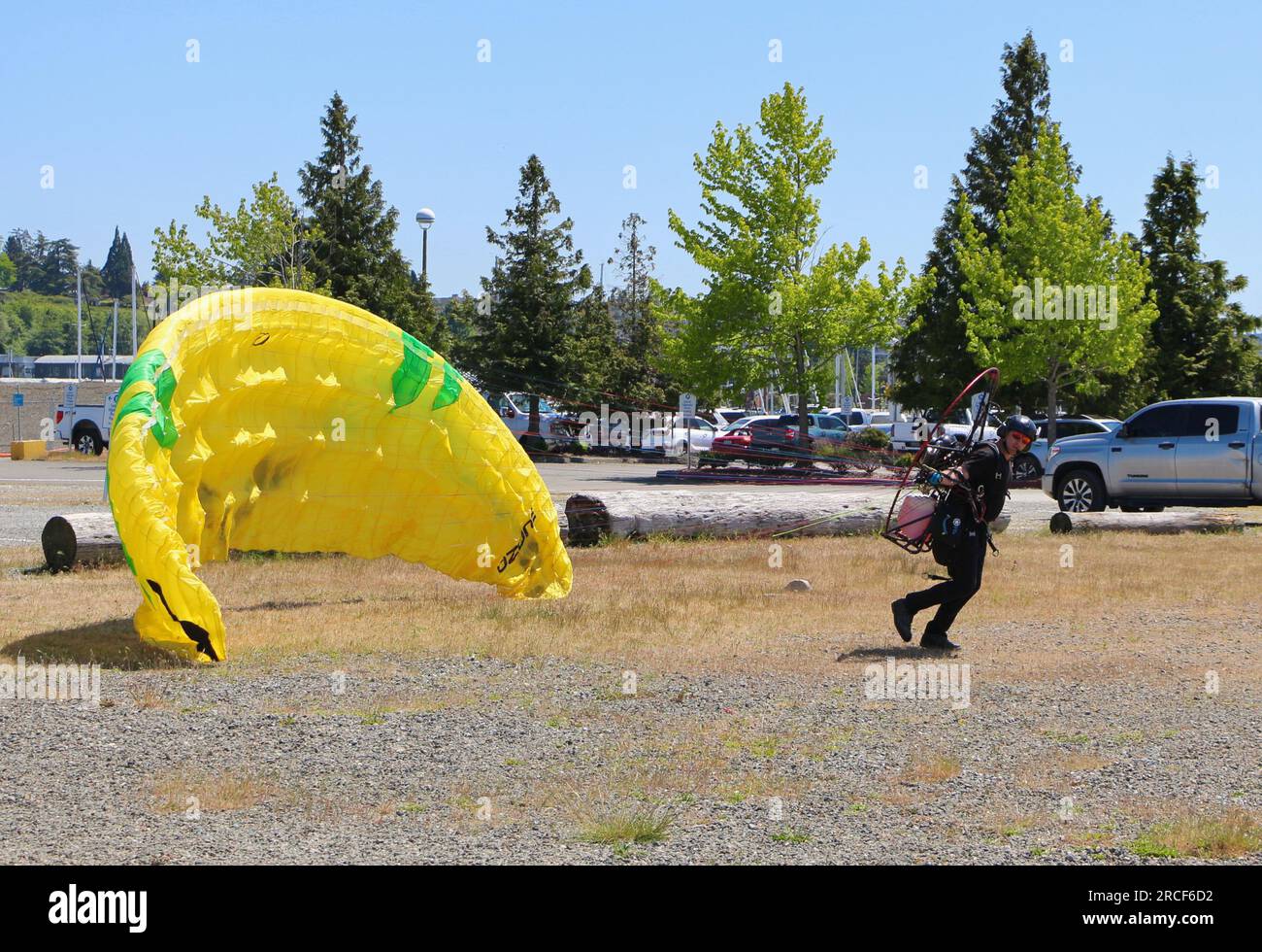 Series of images of a Powered paraglider launching from near the ...