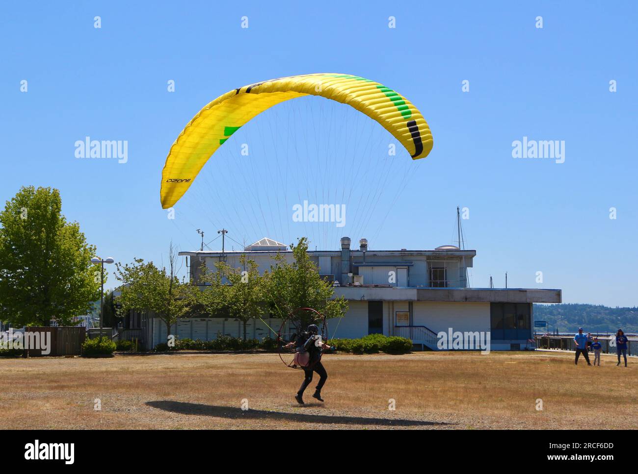 Series of images of a Powered paraglider launching from near the ...