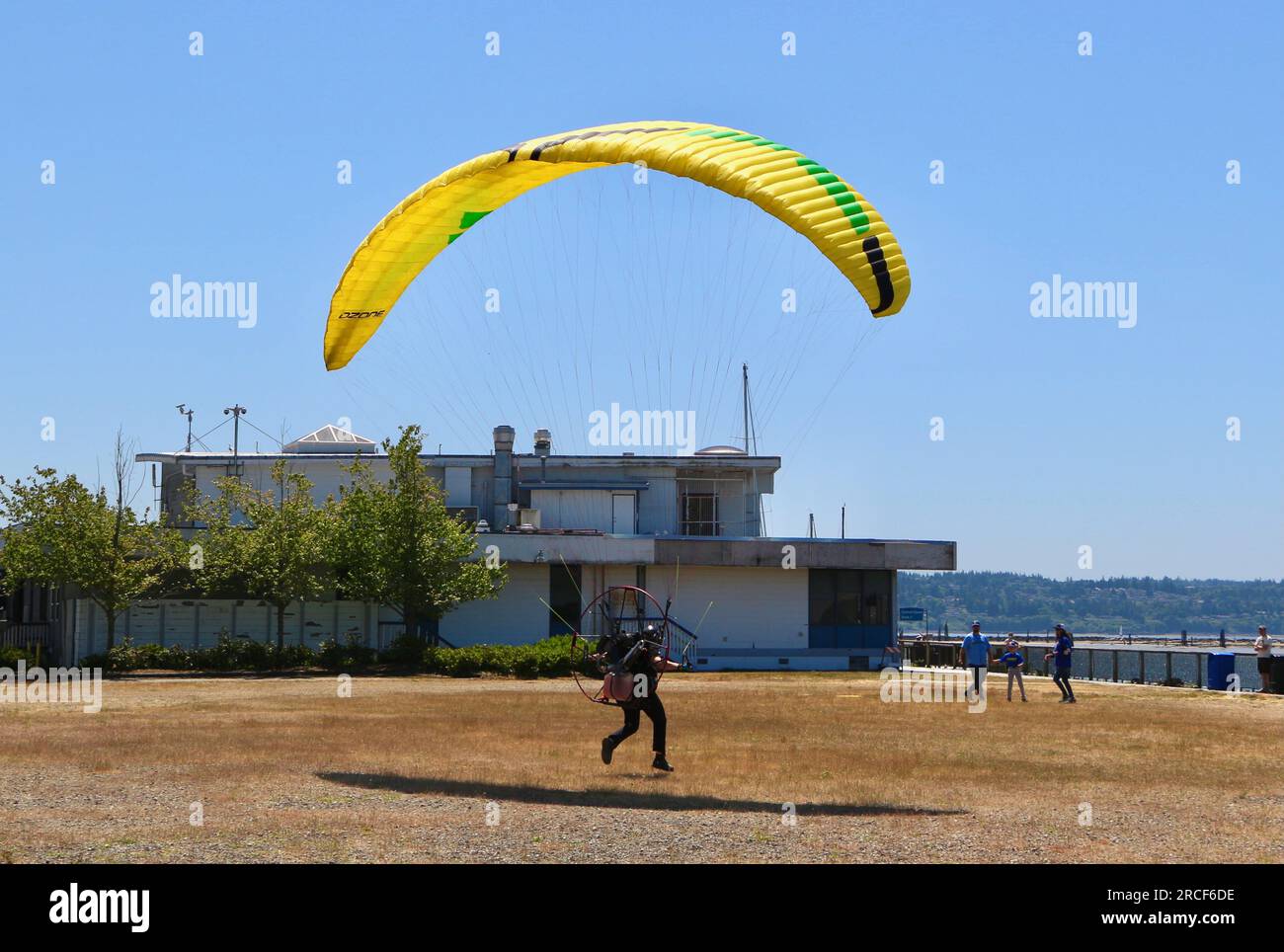 Series of images of a Powered paraglider launching from near the ...