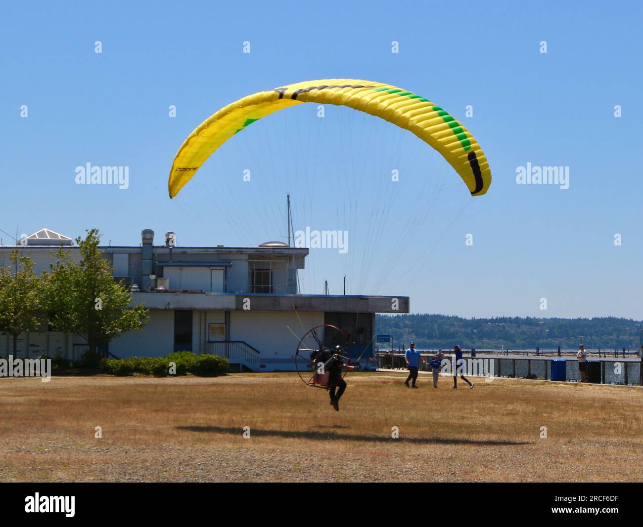 Series of images of a Powered paraglider launching from near the ...
