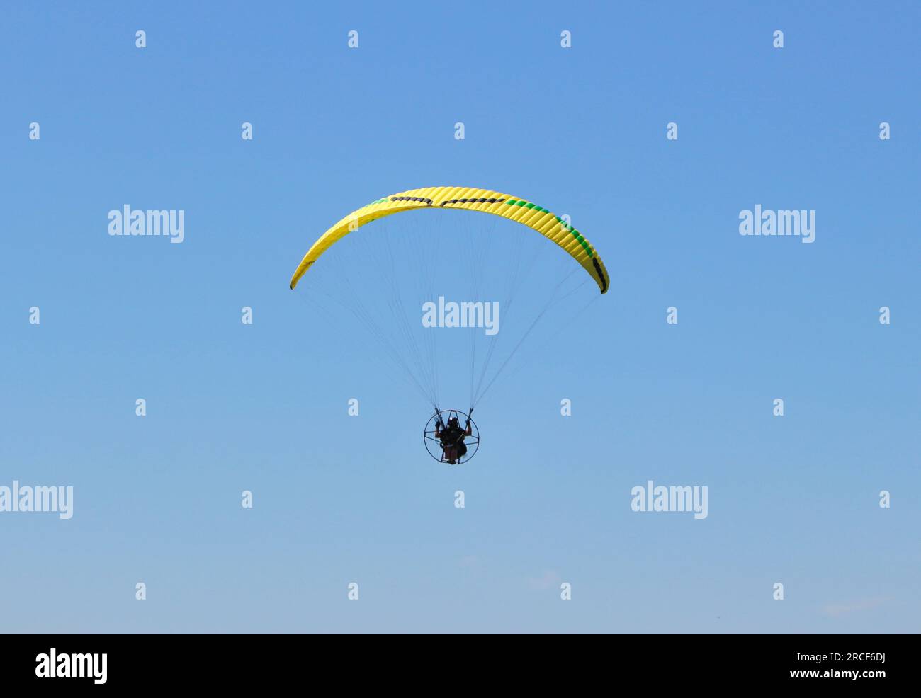 Series of images of a Powered paraglider launching from near the ...