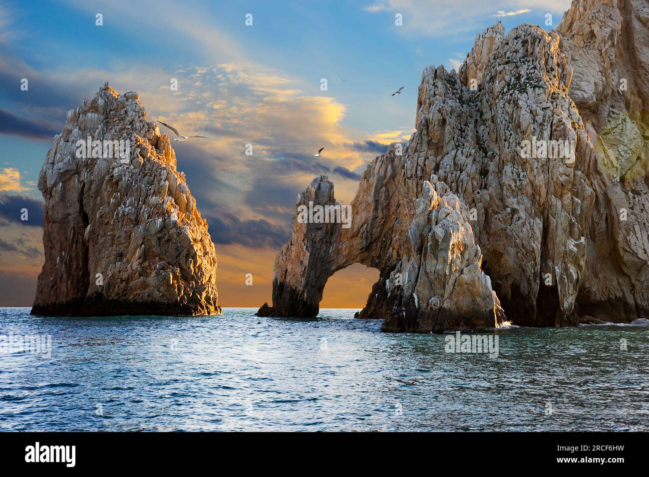 Seagulls soar above Cabo San Lucas's characteristic arch, a rock ...
