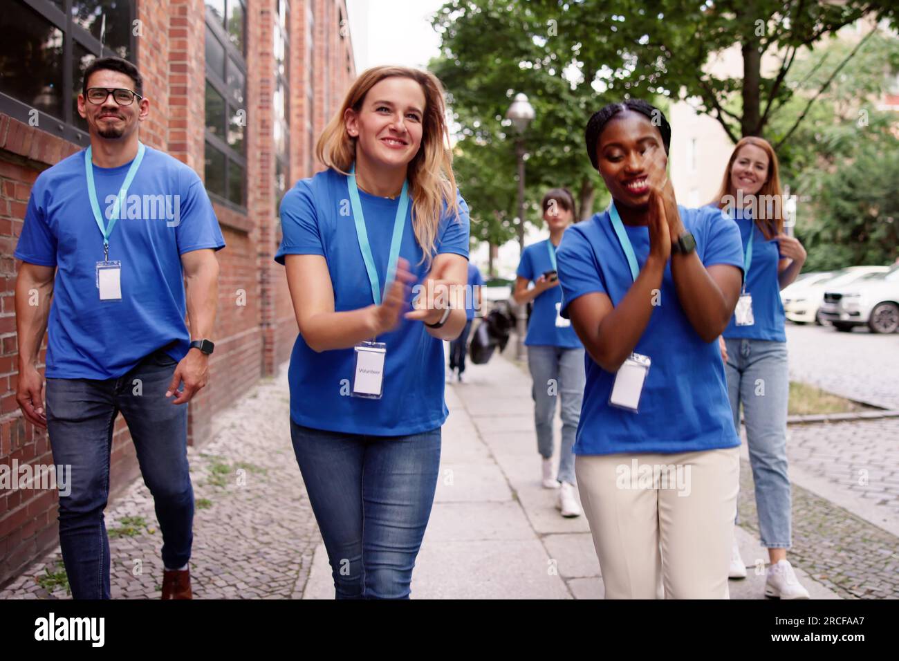 Happy Women In Volunteer Uniform Dancing To Music. Fun Community Stock ...