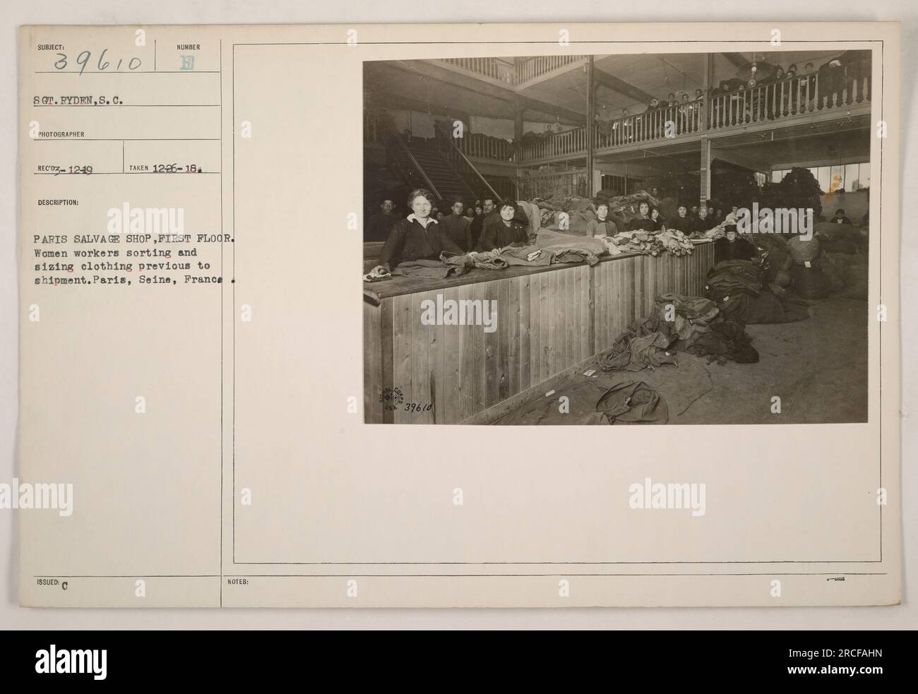 Women workers in a Paris salvage shop on the first floor, sorting and ...