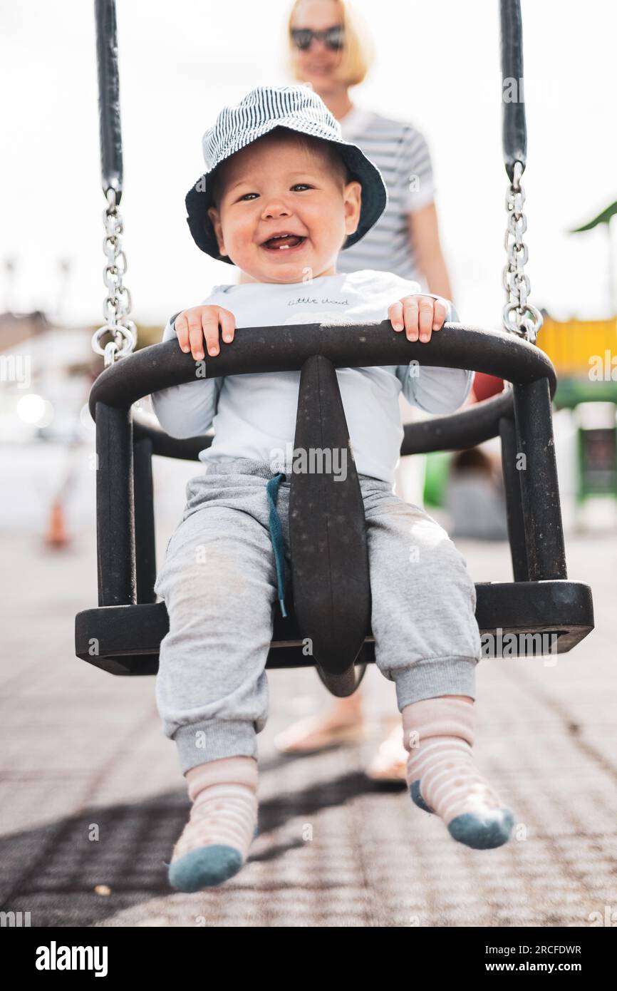 Child kid pushing swing hi-res stock photography and images - Alamy