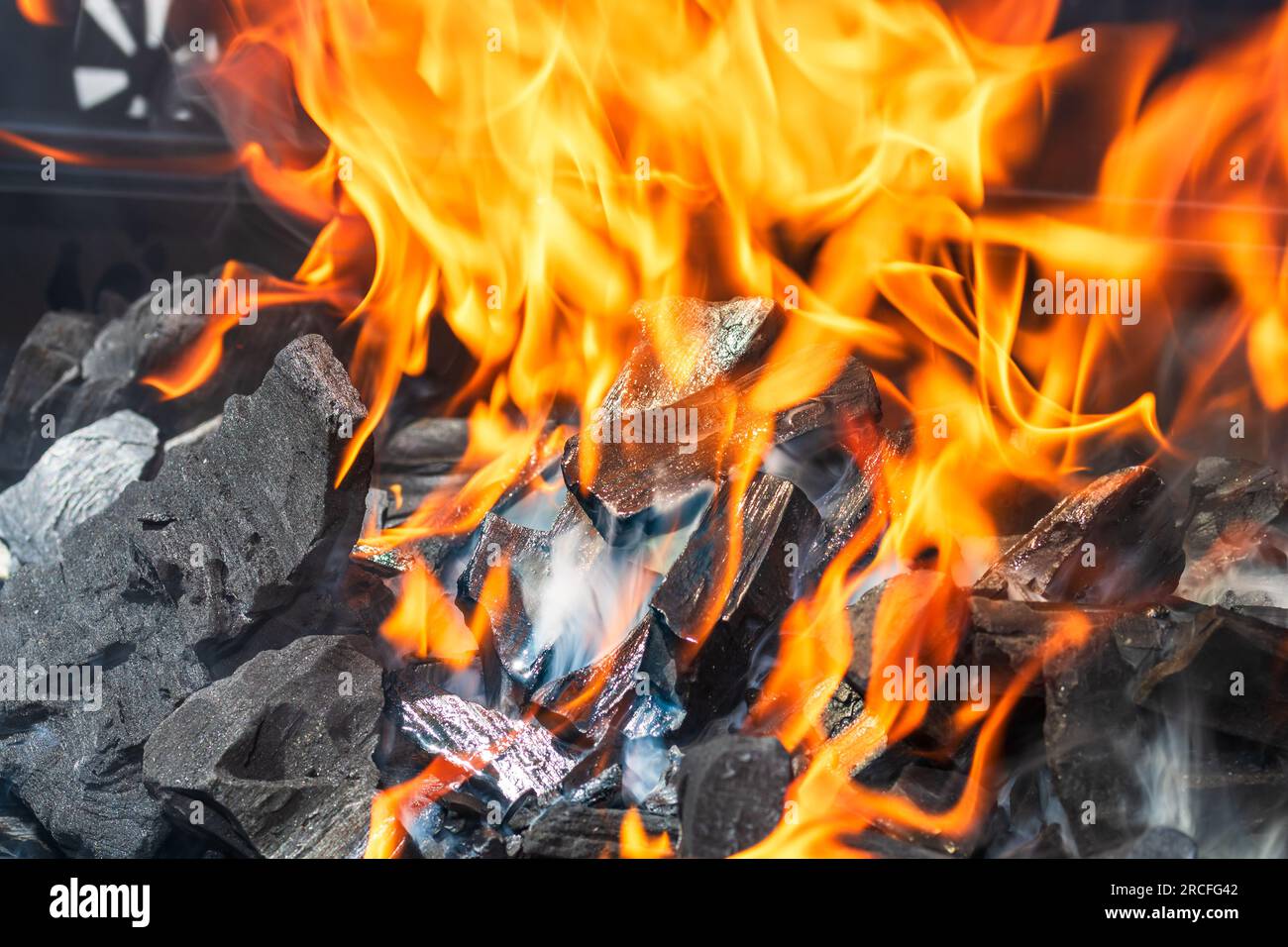 Barbecue grill pit with glowing and flaming hot open fire with red ...