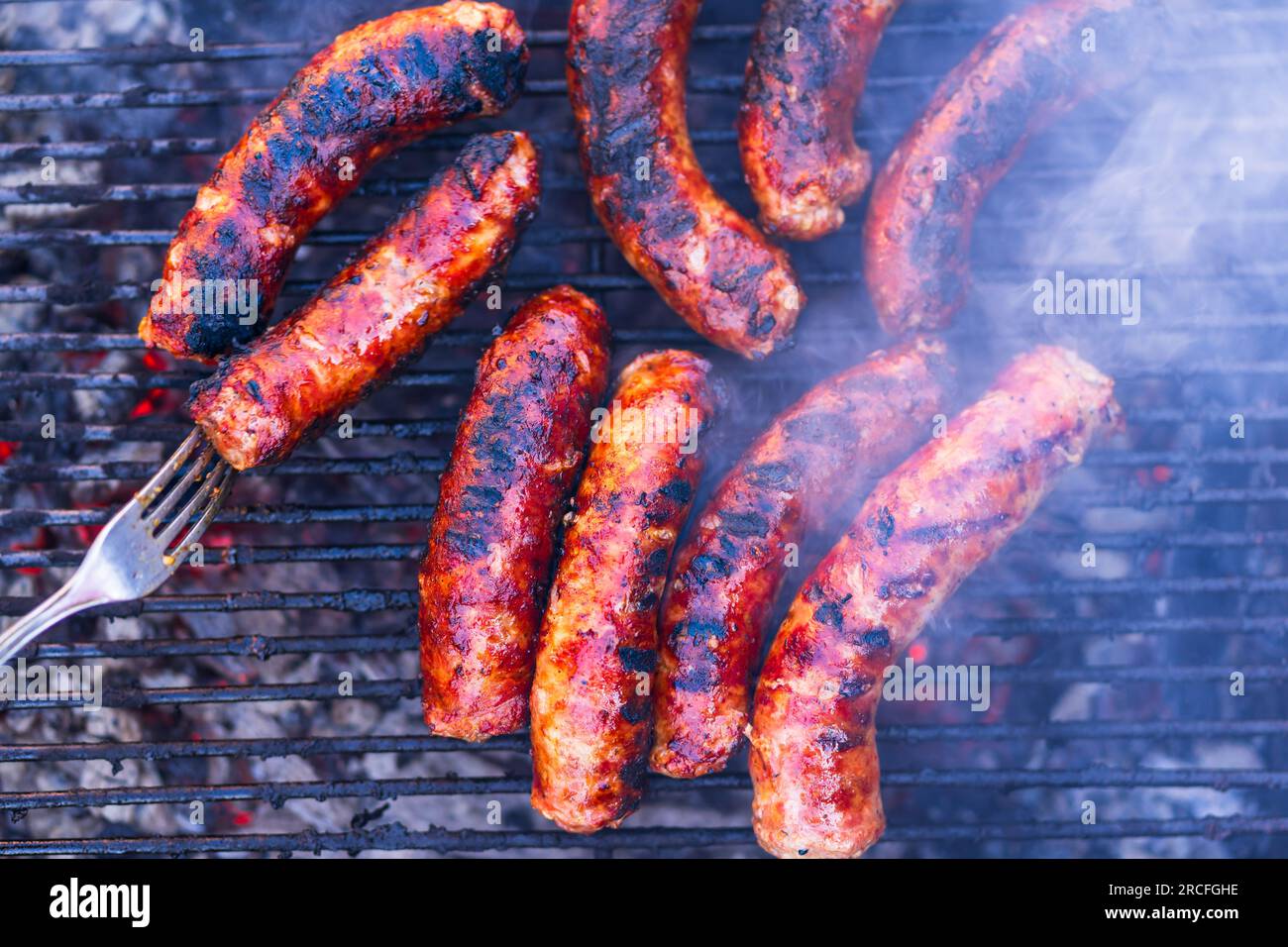 Sausages grilled on a charcoal barbeque. Top view of tasty barbecue ...