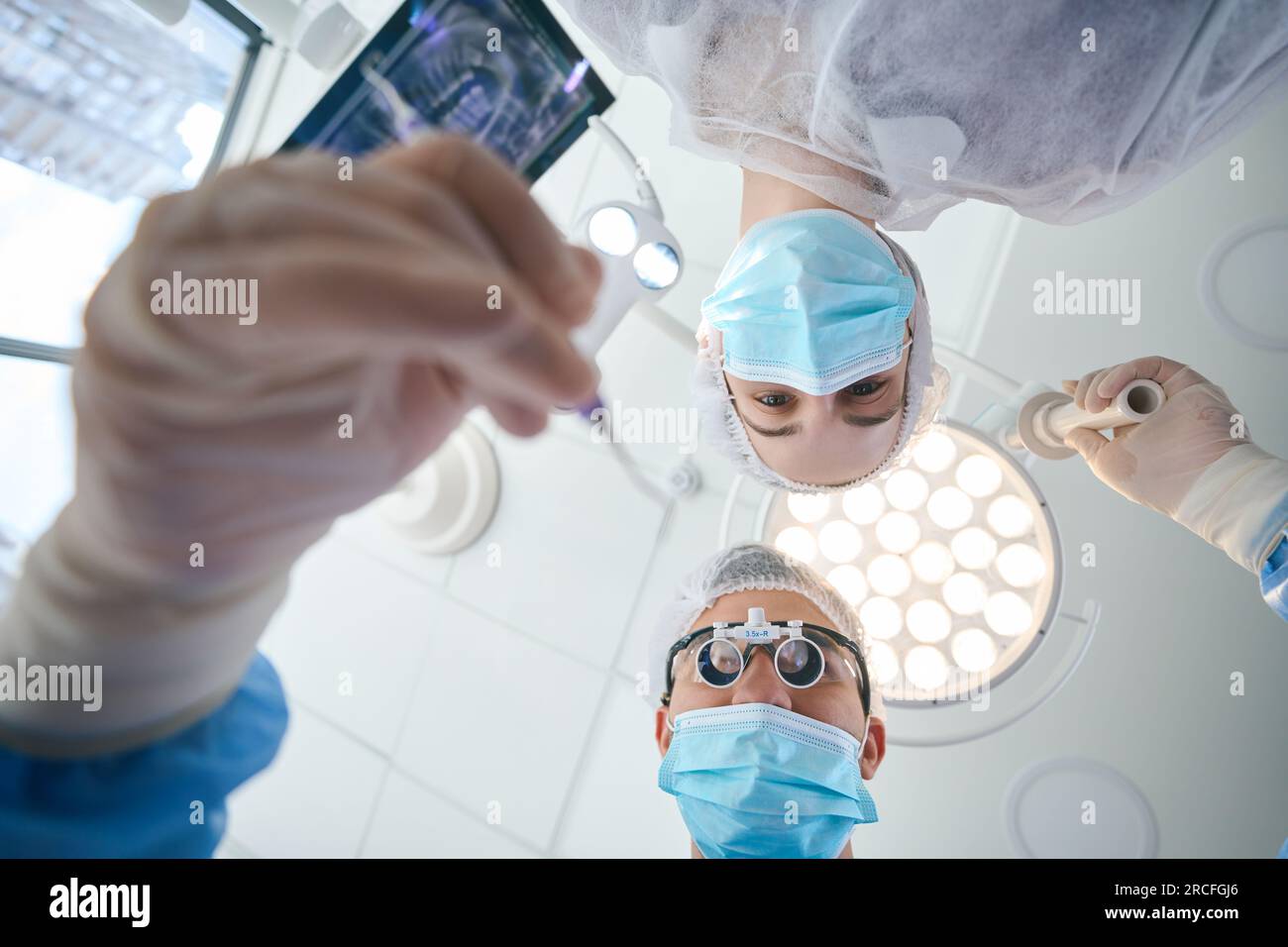 Surgeon dentist with an assistant at workplace in t operating room ...