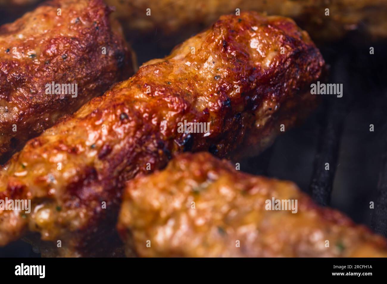 Traditional Romanian food Meat Balls "mici" on grill. Tasty meat balls ...