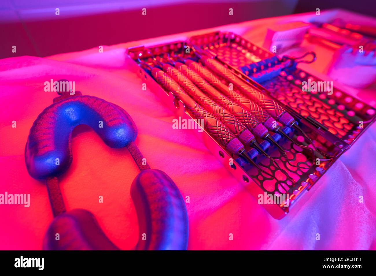 Dental instruments are laid out for sterilization by an infrared lamp ...