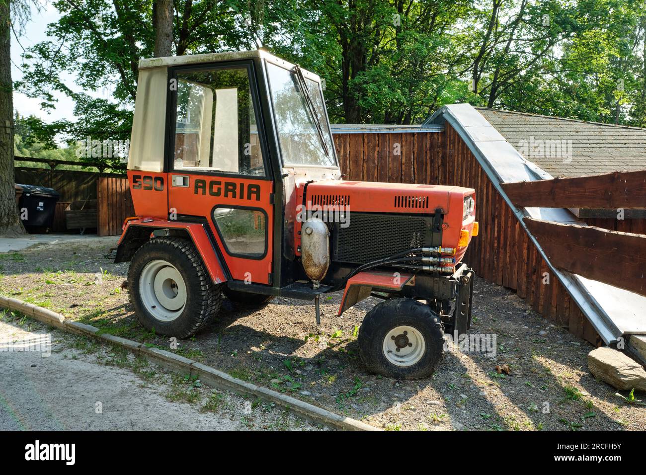 Red compact tractor utility Agria 590 in the yard of a country house ...