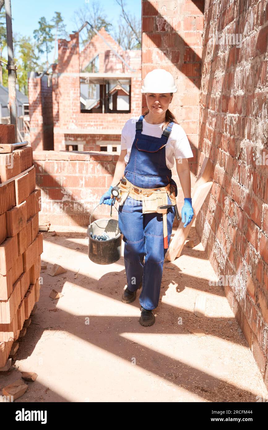 Woman laying bricks hi-res stock photography and images - Alamy