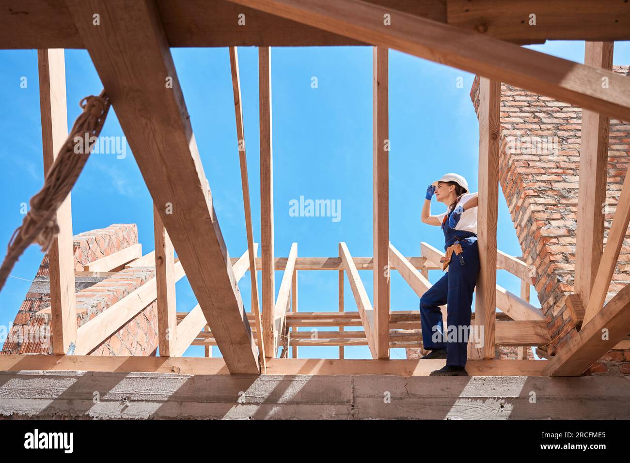 Female construction standing on roof hi-res stock photography and ...