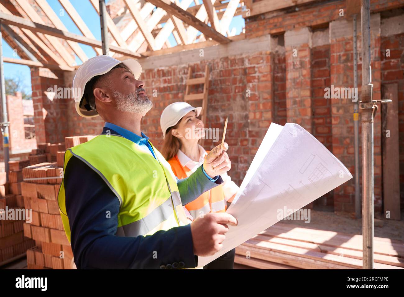 Building inspectors holding project, checking quality of roof ...