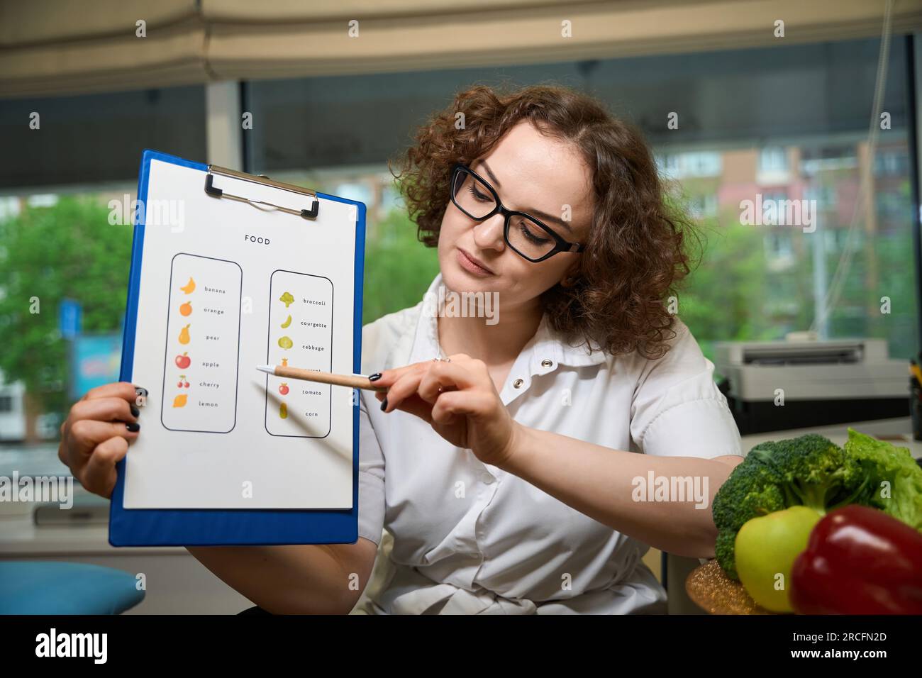 Doctor demonstrates visual aid with nutritional characteristics of ...