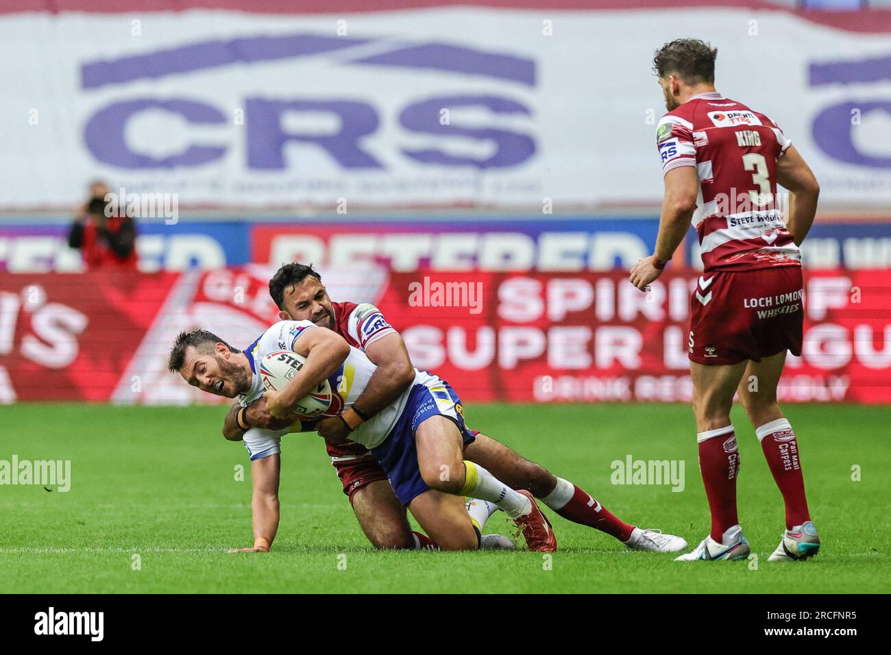 Stefan Ratchford #4 of Warrington Wolves is tackled by Bevan French #2 ...