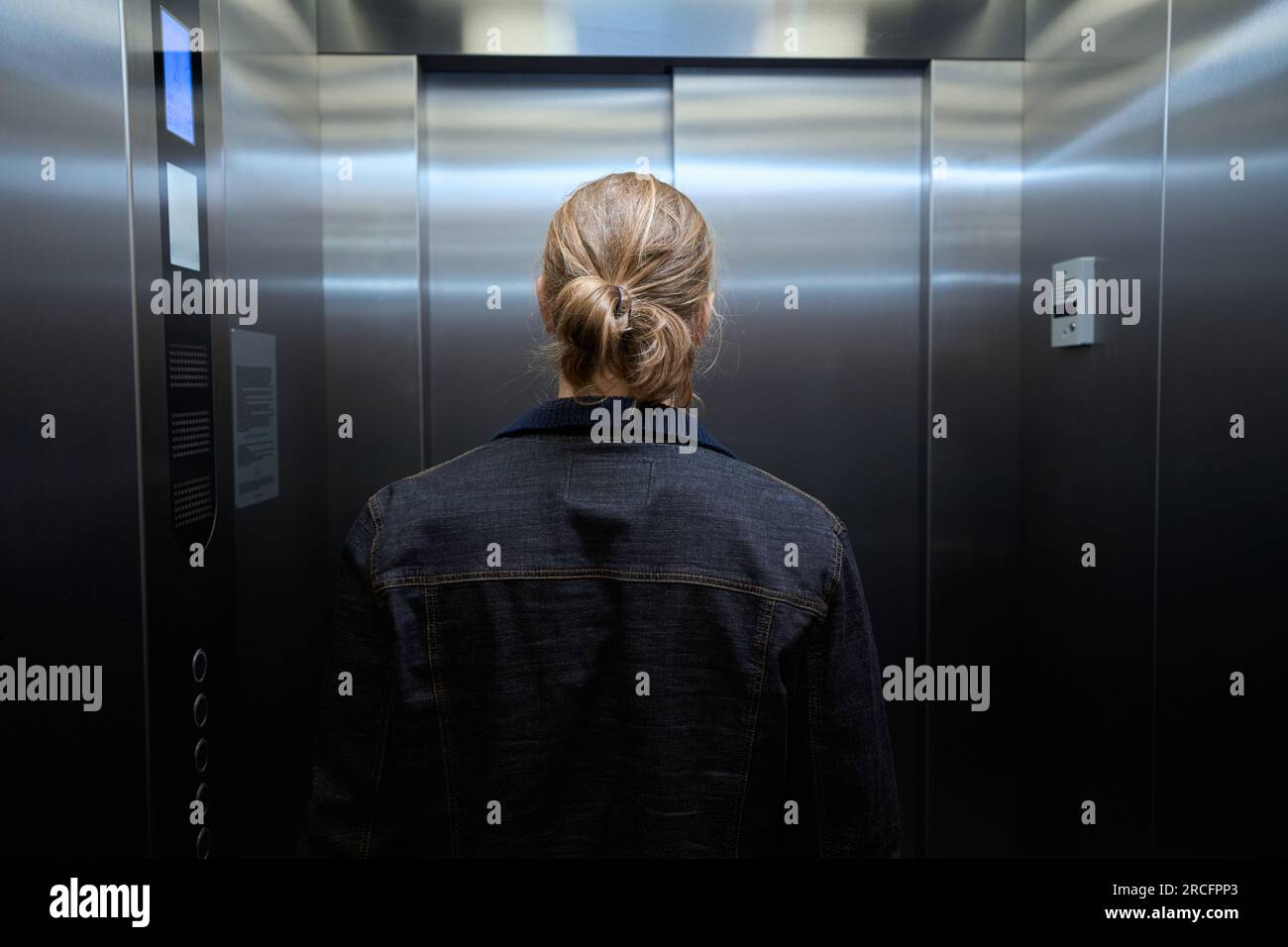 Male in a denim jacket is in passenger elevator cabin Stock Photo - Alamy