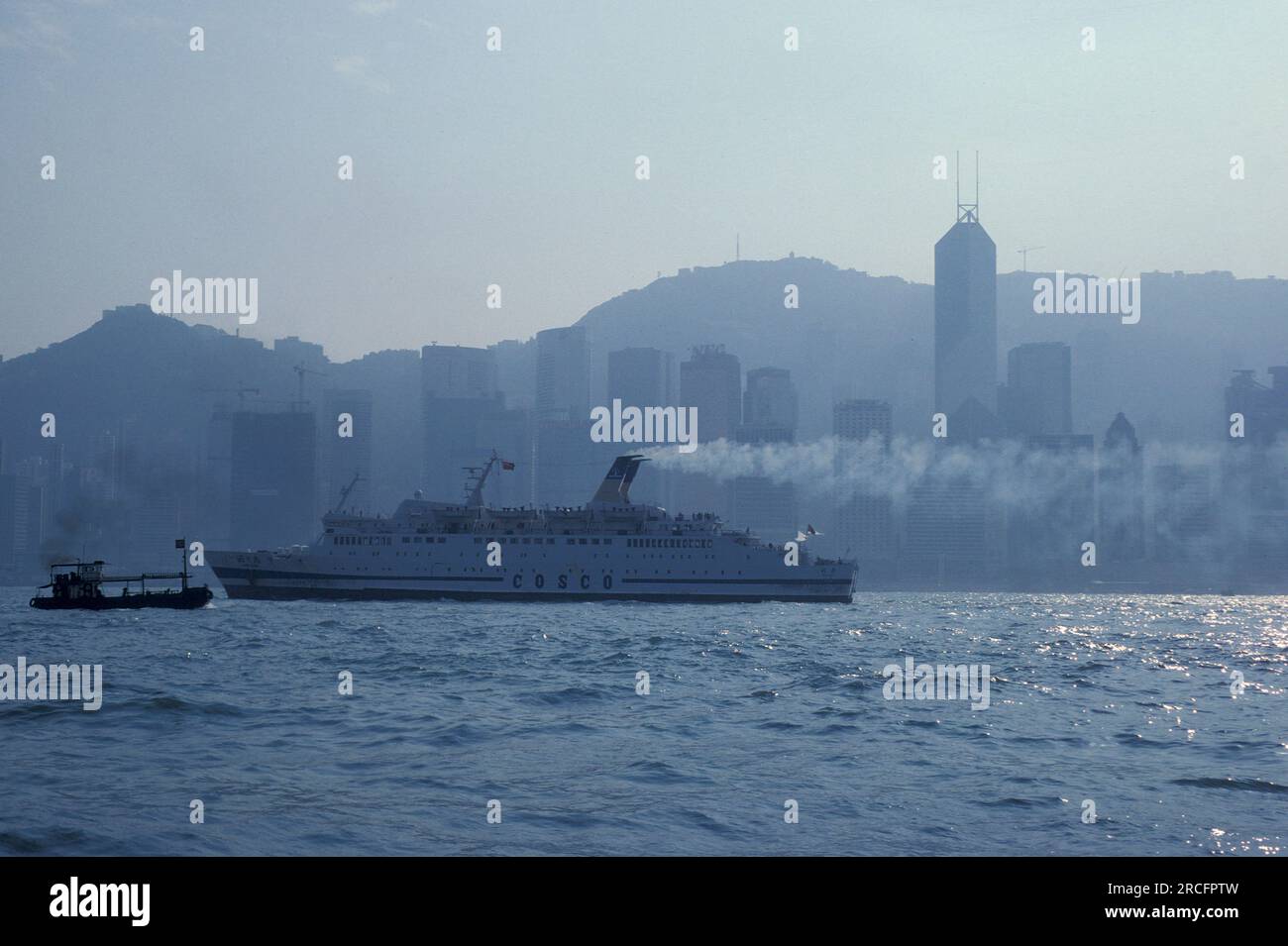 a cosco ship with view on the Victoria harbour in front of the Skyline ...