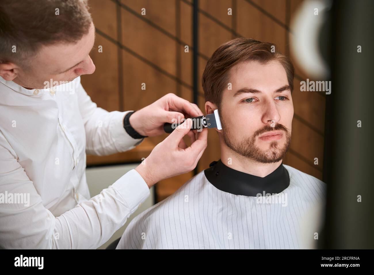 Good looking barber working in modern salon Stock Photo - Alamy