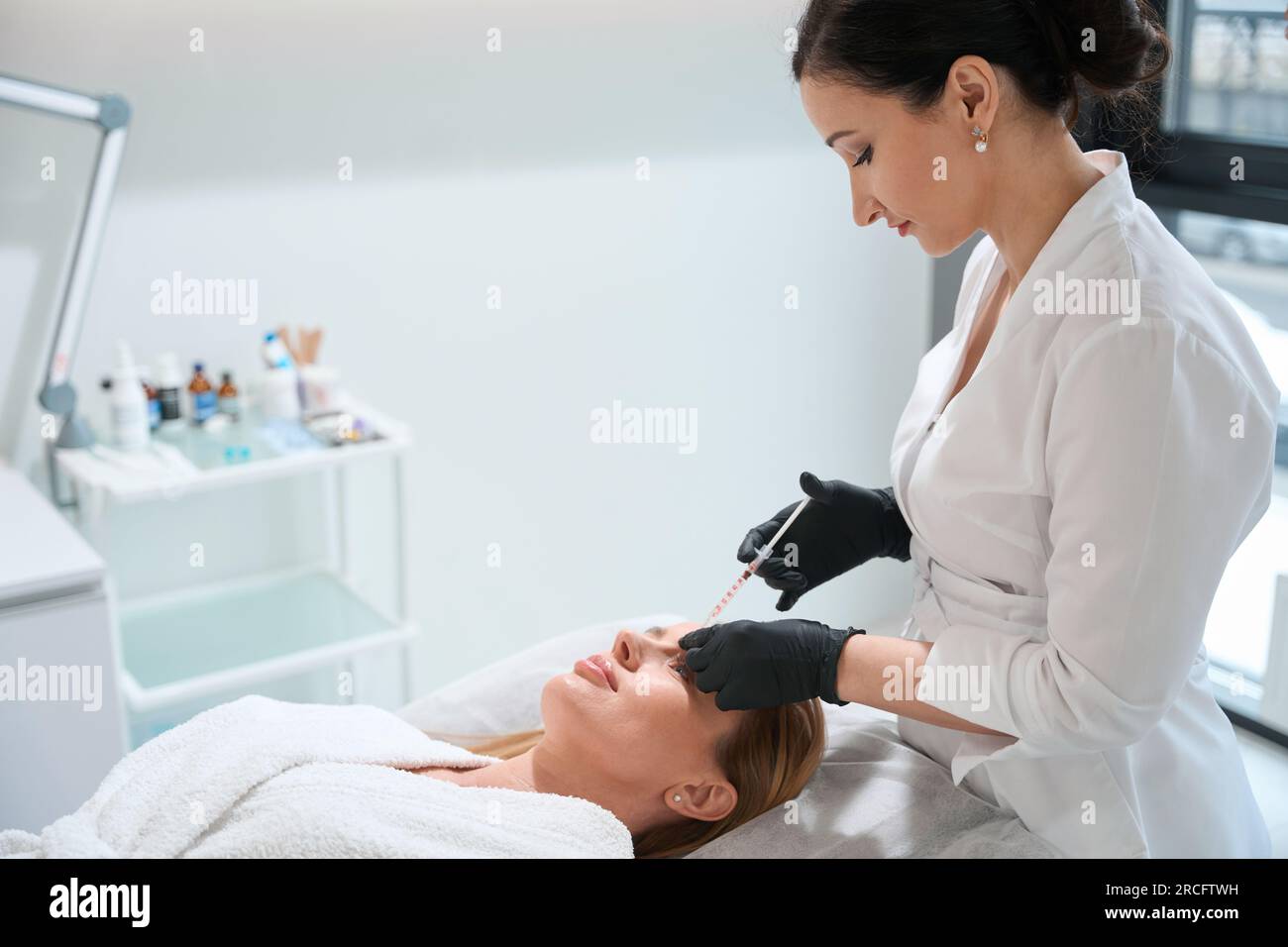 Client on injection procedure in aesthetic medicine clinic Stock Photo ...