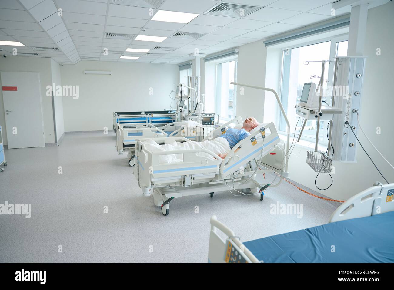 Patient on bed in resuscitation with hospital equipment Stock Photo - Alamy