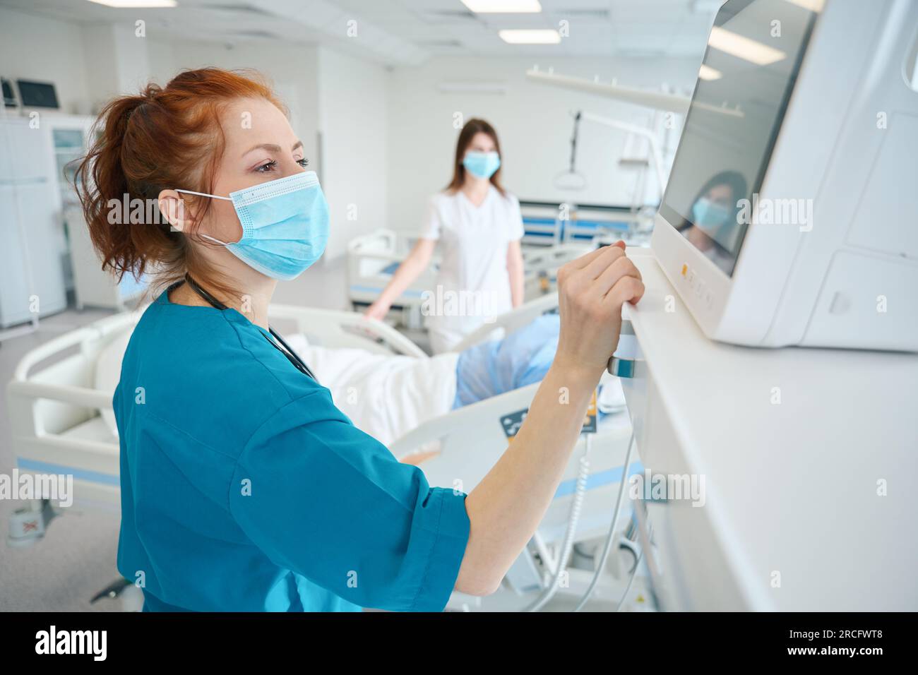 Physicians assessing condition of patient well-being in the intensive ...