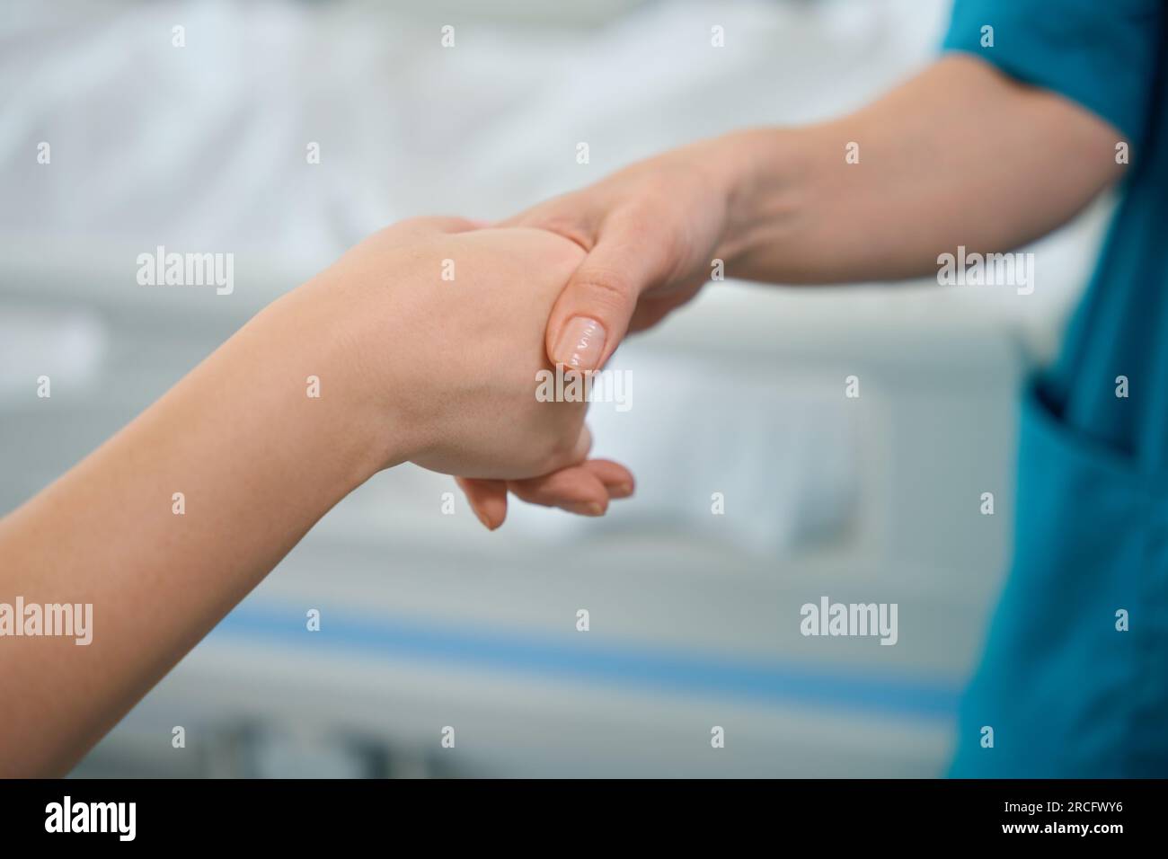 Female medic shaking hands with her colleague in hospital Stock Photo ...
