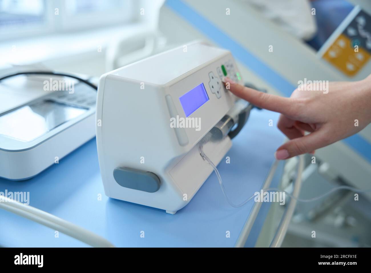 Doctor is adjusting syringe pump in hospital Stock Photo - Alamy