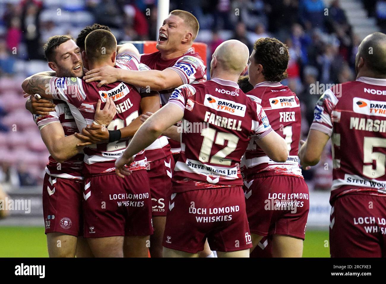 Wigan Warriors' Jake Wardle (left) celebrates scoring his side's third ...