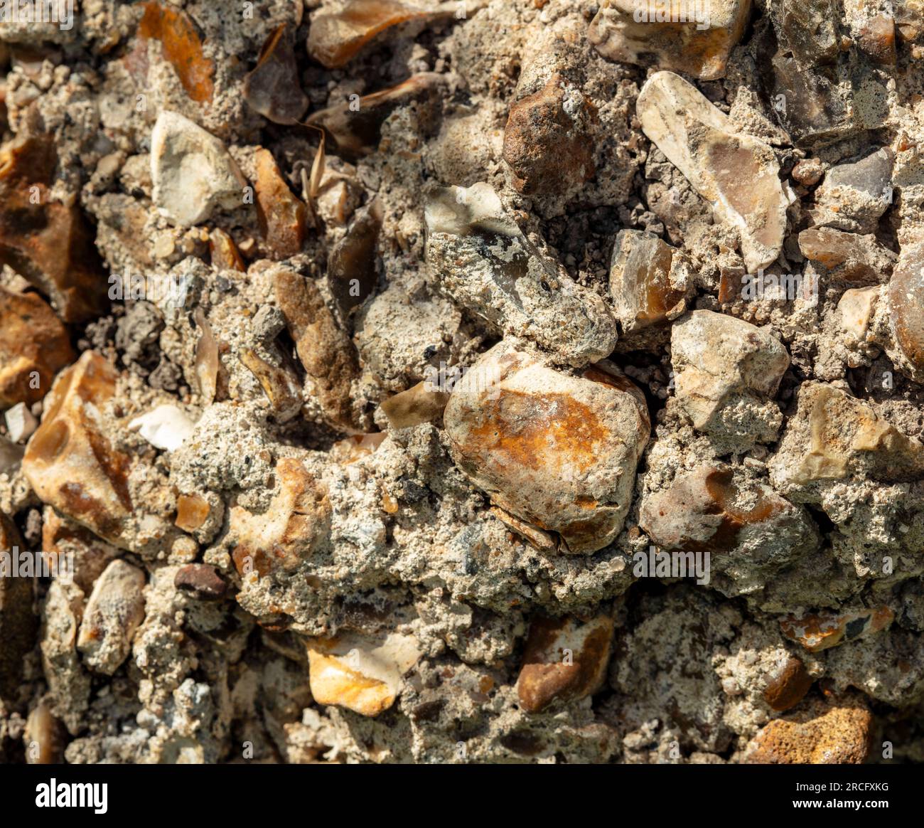 Textured semi abstract close up of section of aggregate rock in ...