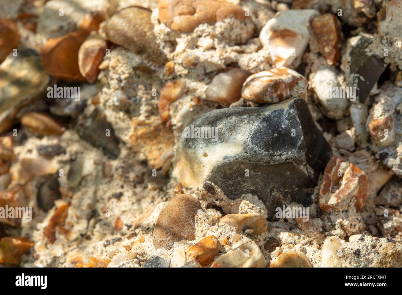 Textured semi abstract close up of section of aggregate rock in ...