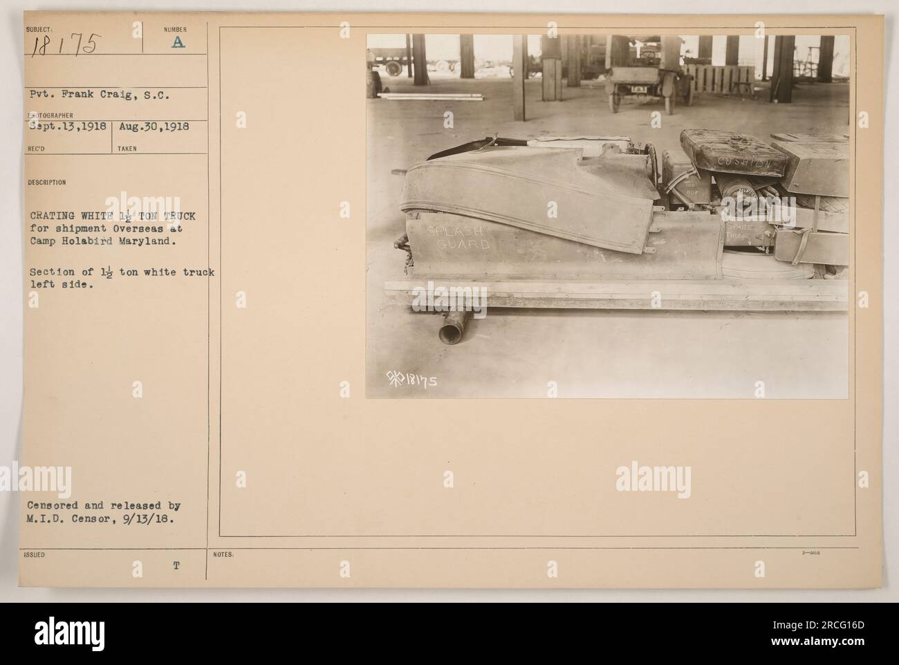 Pvt. Frank Craig is shown crating a 1 ton white truck for shipment ...