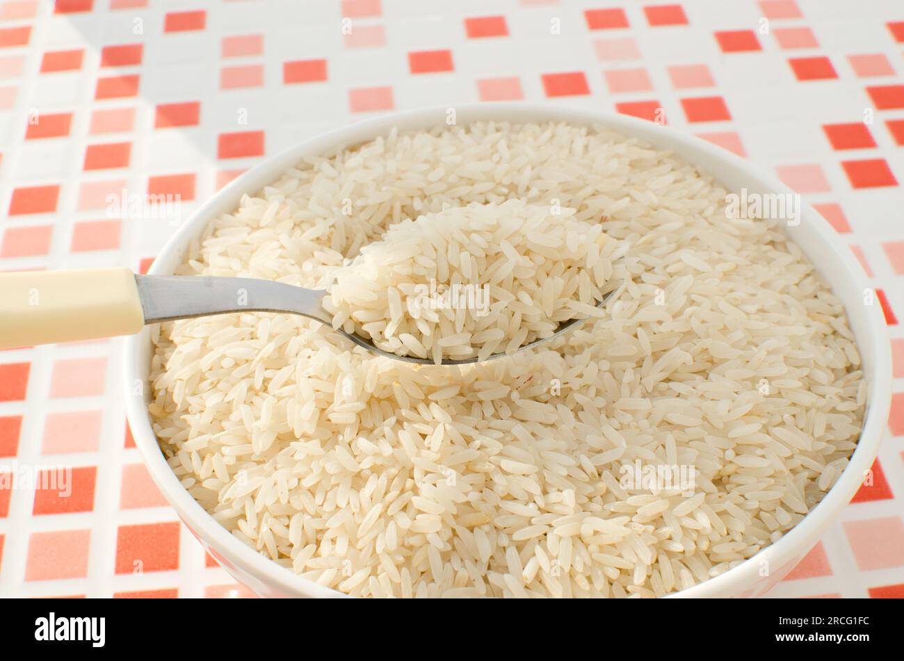 Detail of a bowl of uncooked rice, a versatile and easy-to-prepare food ...